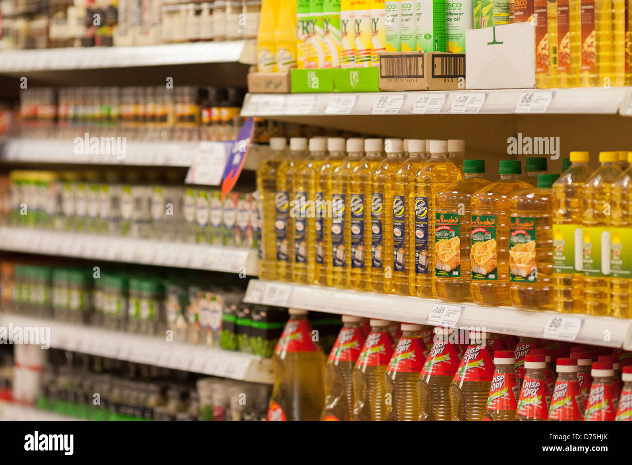 Bottles of cooking oil on supermarket shelves filled with calories ...