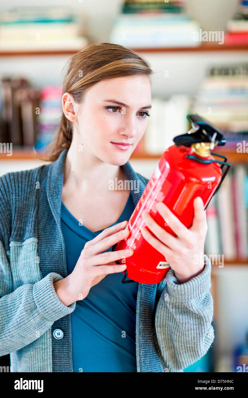 woman inquiring about using a fire extinguisher Stock Photo - Alamy