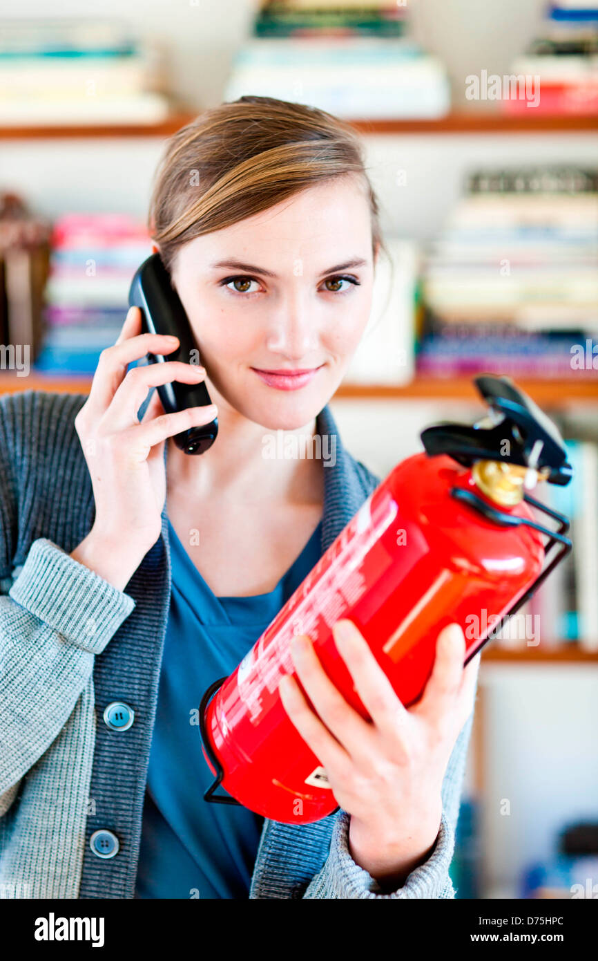 woman inquiring about using a fire extinguisher Stock Photo - Alamy