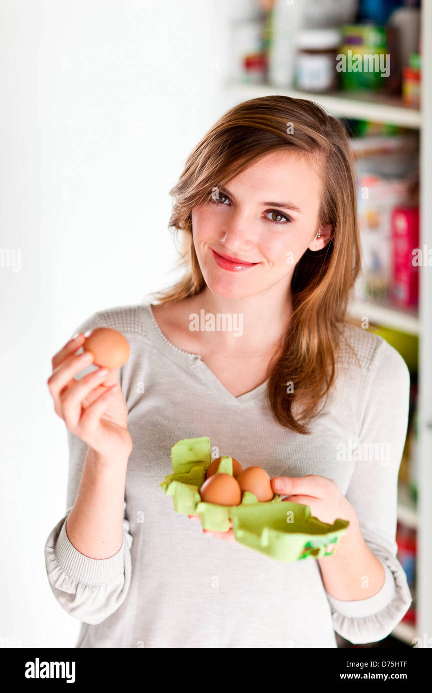 woman holding an egg Stock Photo - Alamy