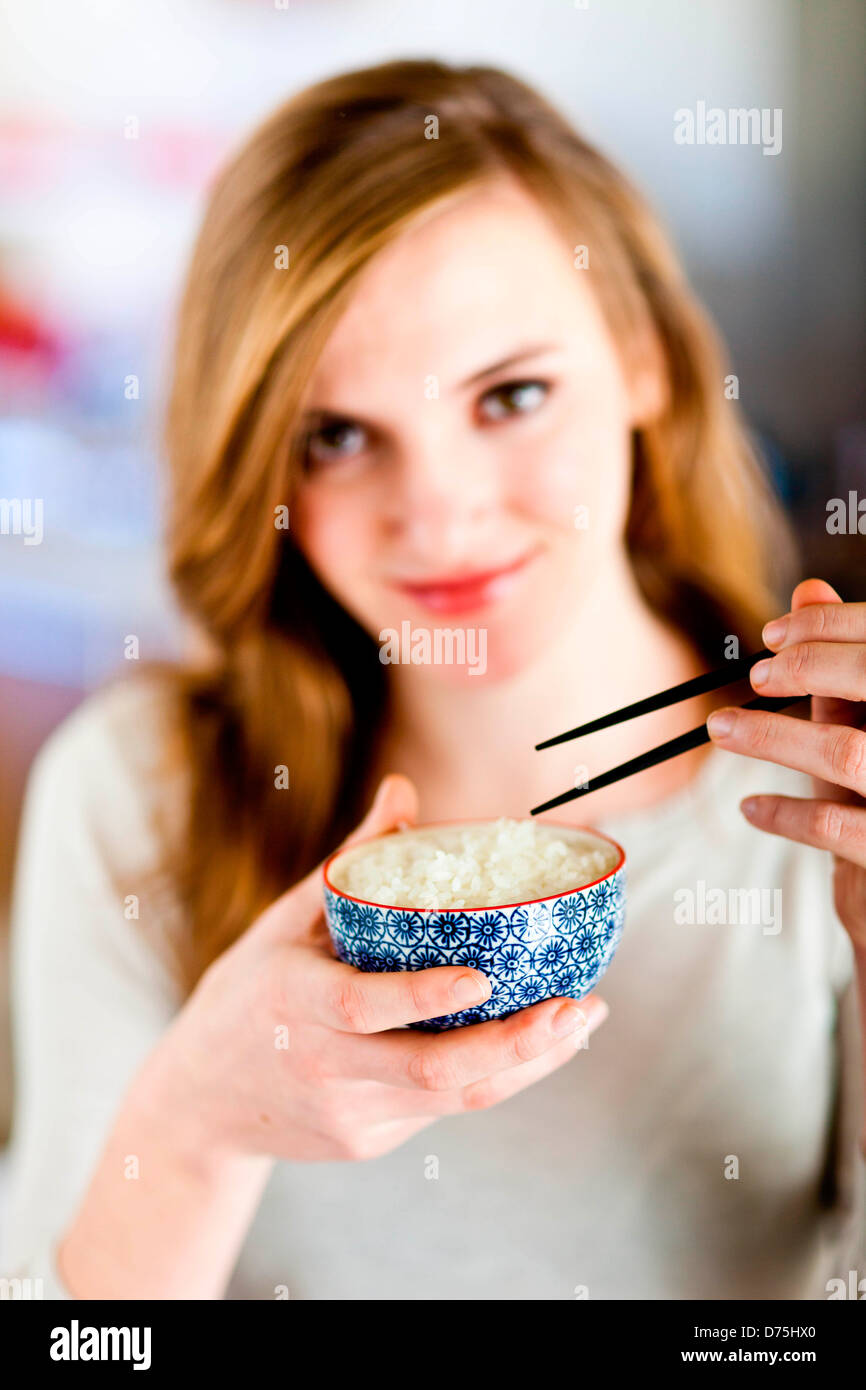 woman eating rice Stock Photo - Alamy