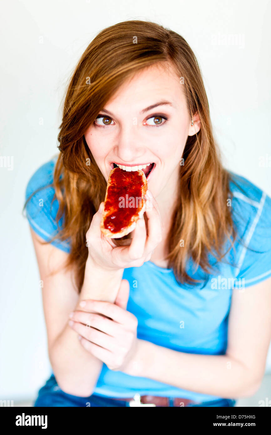 woman eating a jam sandwich Stock Photo - Alamy