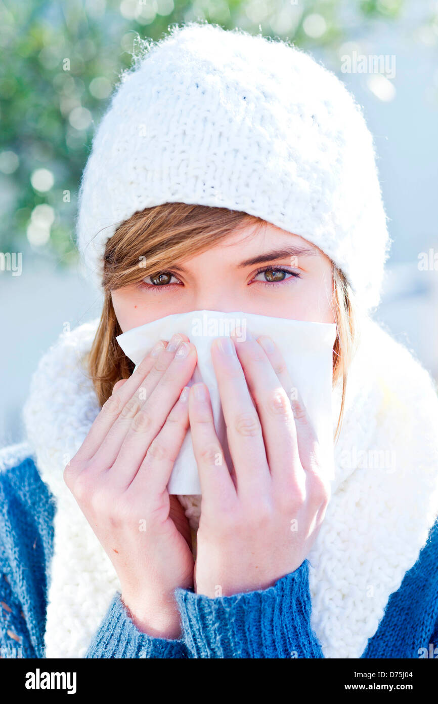 woman suffering from cold blowing her nose with a tissue Stock Photo ...