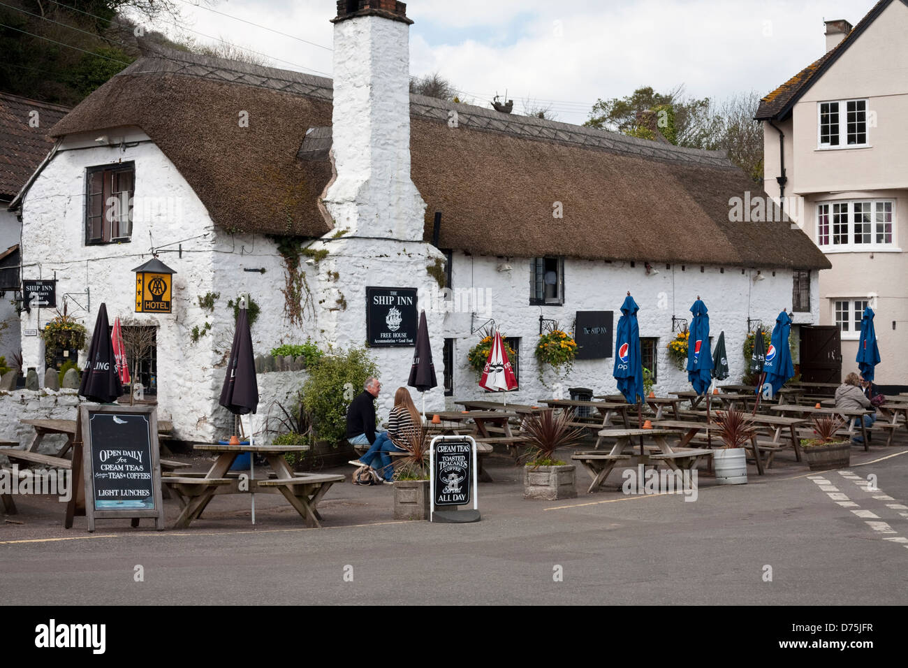 the ship inn a thatched public house in porlock weir with people seated ...