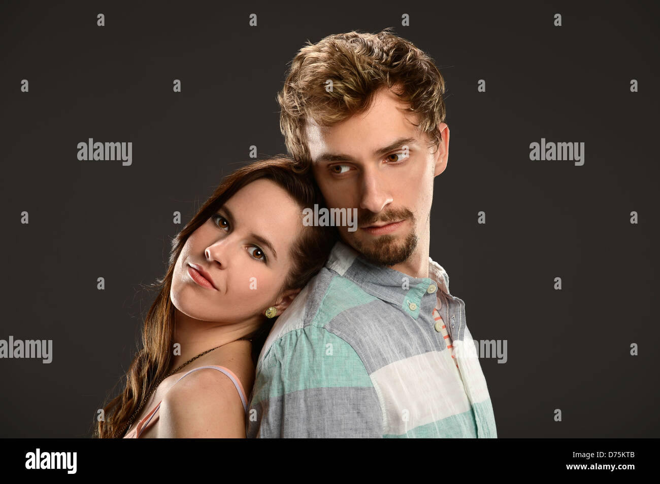 Portrait of young couple over neutral background Stock Photo - Alamy