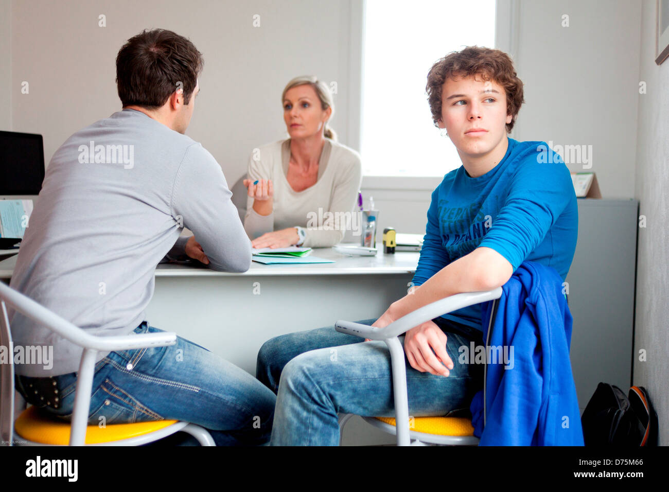 15 year old boy and his father talking with an adult Stock Photo - Alamy