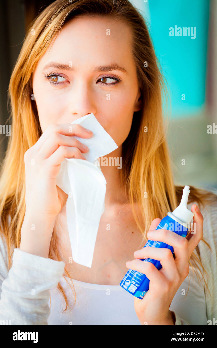Woman using a sterile sea water spray Stock Photo - Alamy