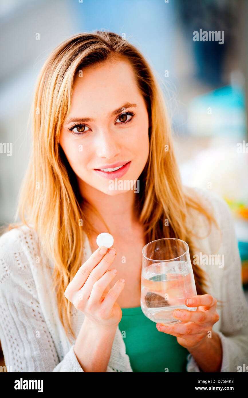 Woman taking an effervescent aspirin tablet Stock Photo - Alamy