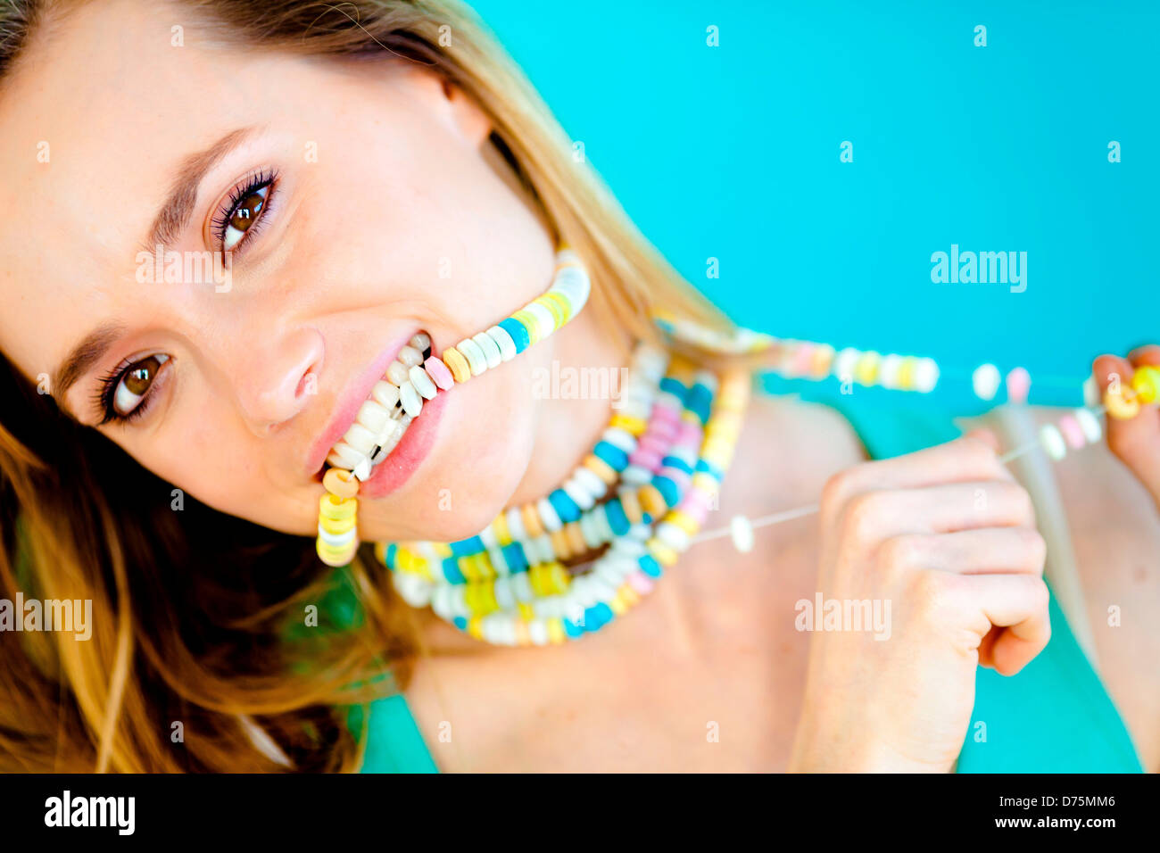 Woman eating candy Stock Photo - Alamy