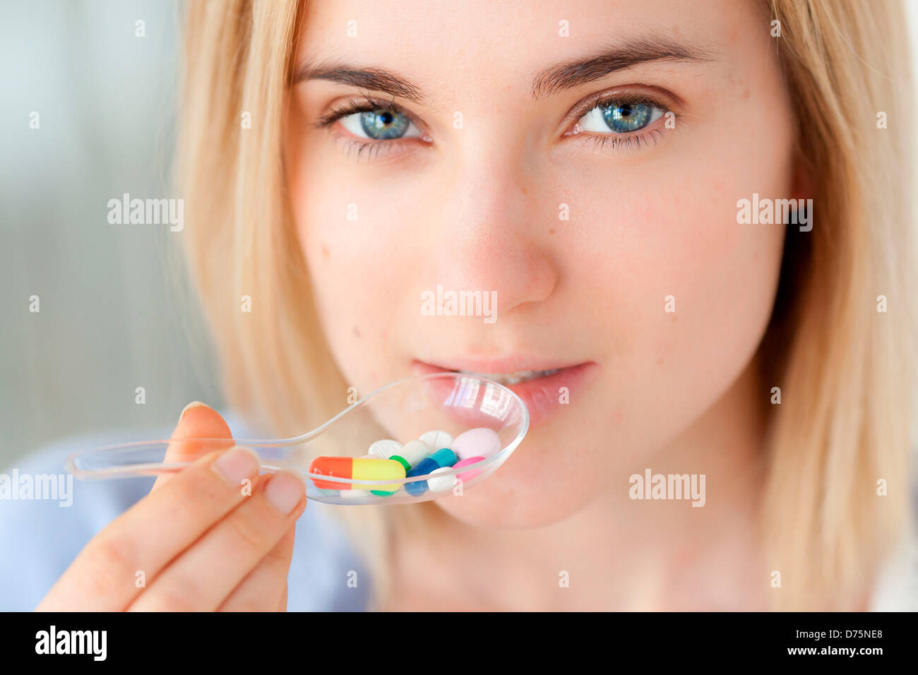 Woman taking medicine Stock Photo - Alamy
