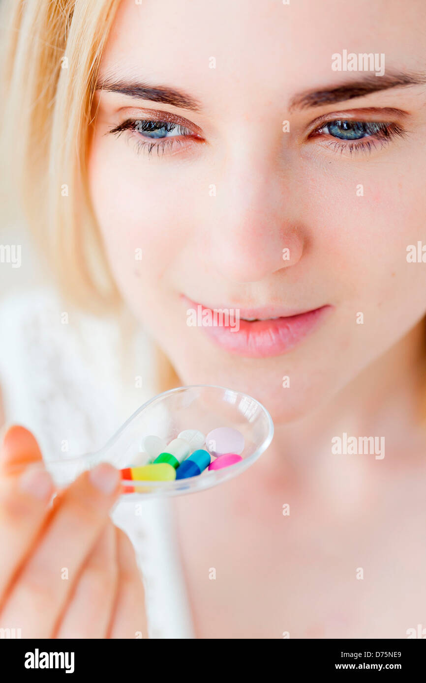 Woman taking medicine Stock Photo - Alamy