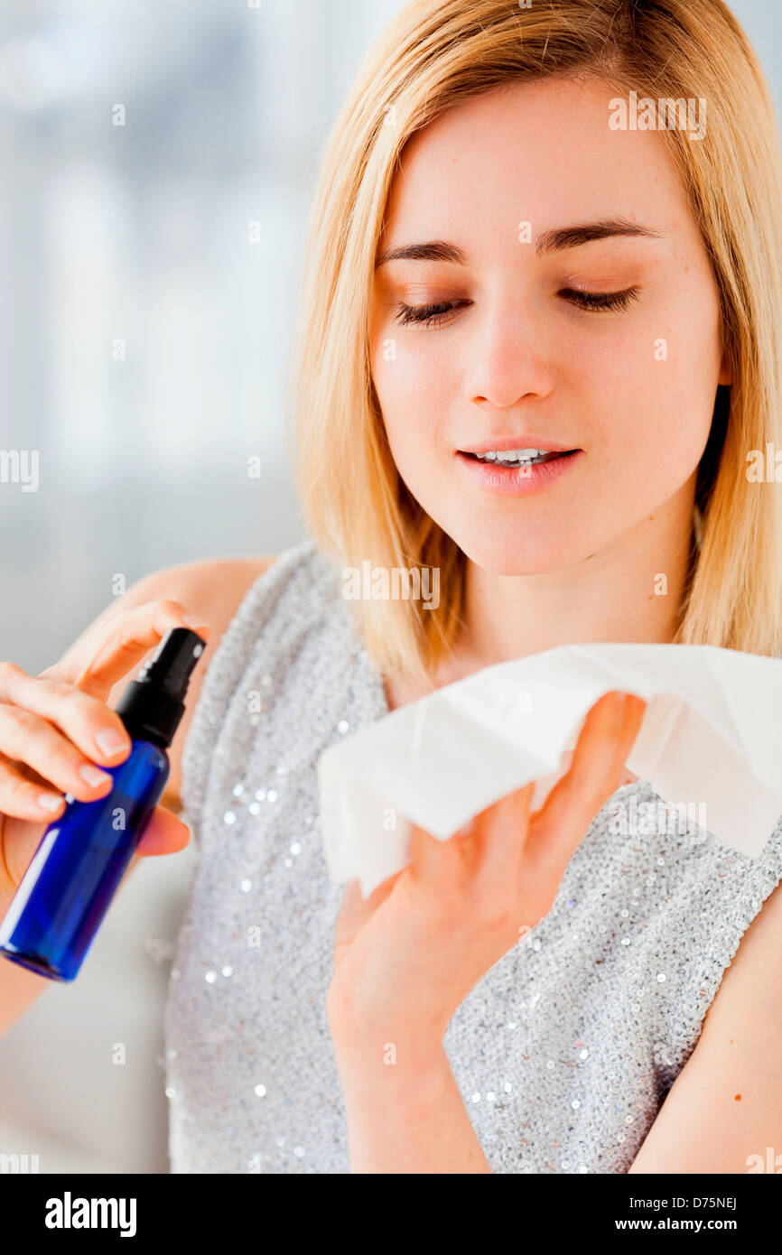 Woman spraying essential oil on a tissue Stock Photo - Alamy