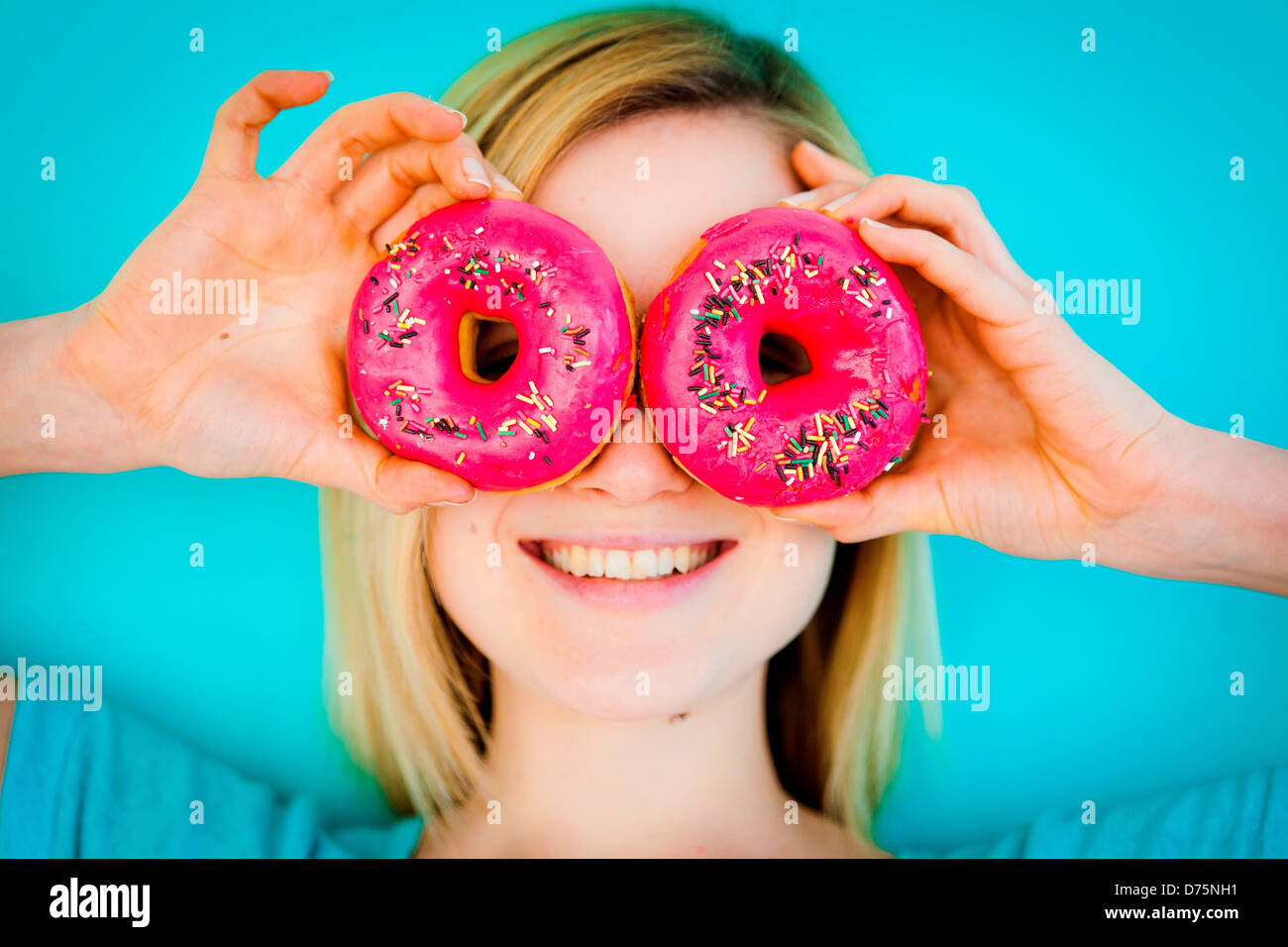 Woman eating donuts Stock Photo - Alamy