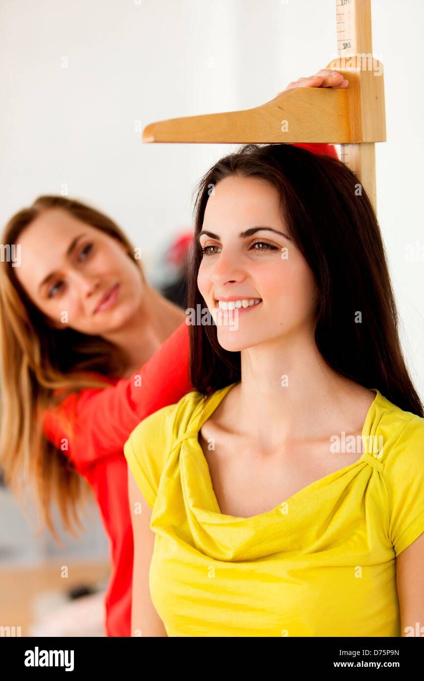 Woman under height gauge Stock Photo - Alamy