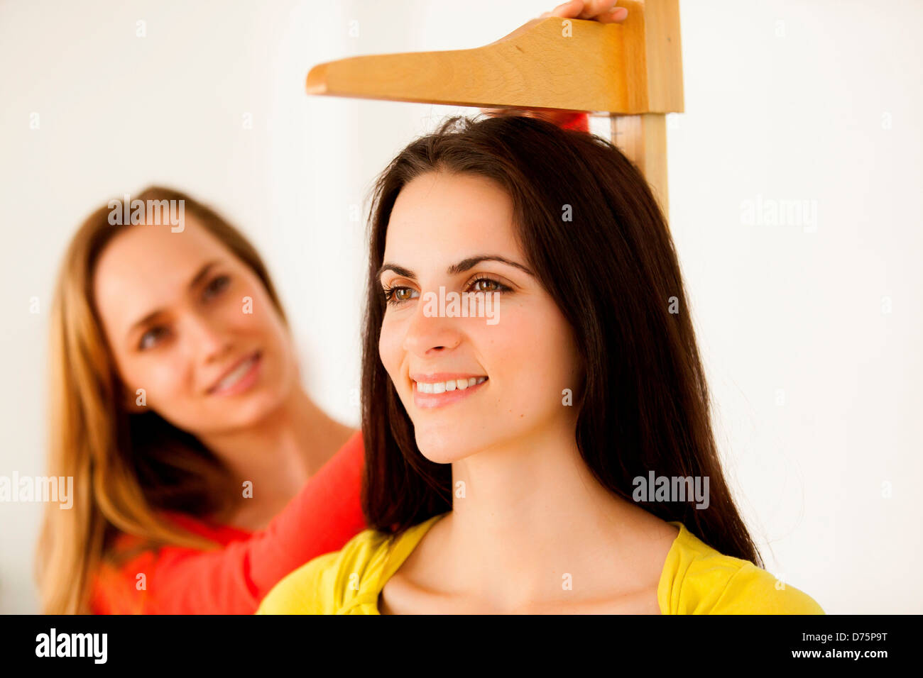 Woman under height gauge Stock Photo - Alamy