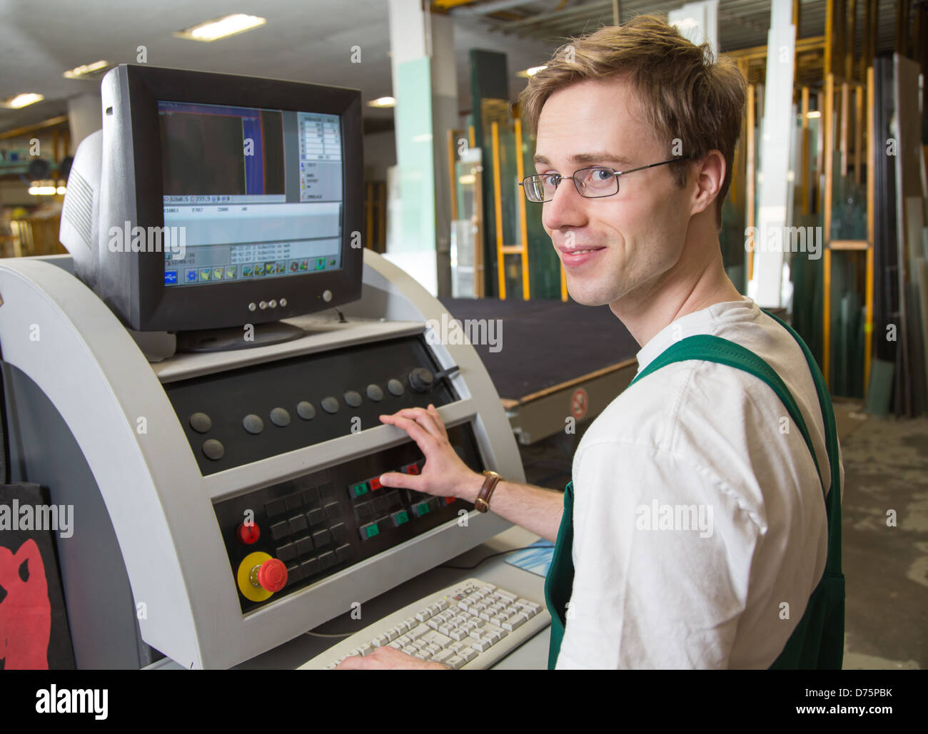 worker in glazier's workshop operating a cutting machine Stock Photo ...