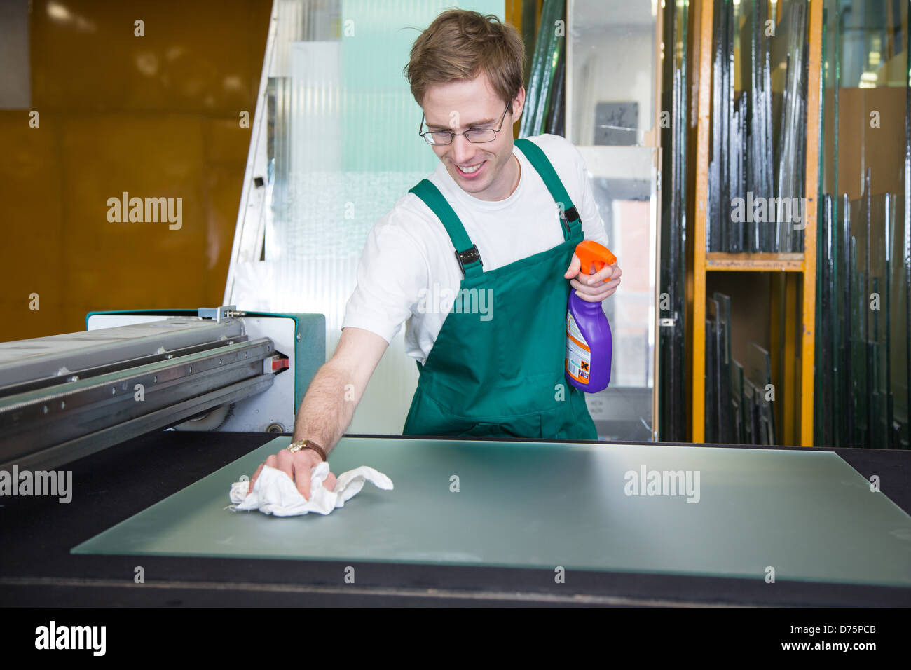 glazier in workshop cleaning a glass Stock Photo - Alamy
