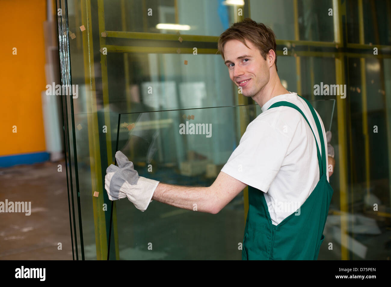 Worker in glazier's workshop, warehouse or storage handling glass Stock ...