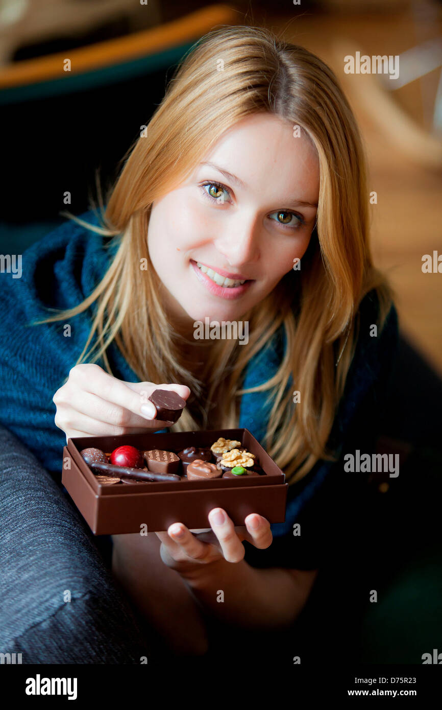 Woman eating chocolate Stock Photo - Alamy
