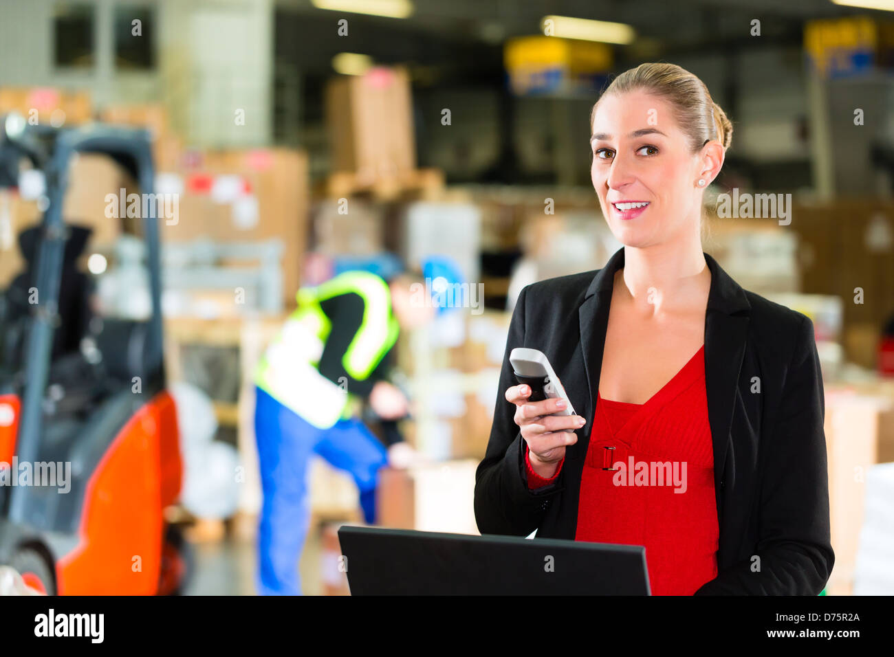 Friendly Woman, dispatcher or supervisor using cell phone and laptop at ...