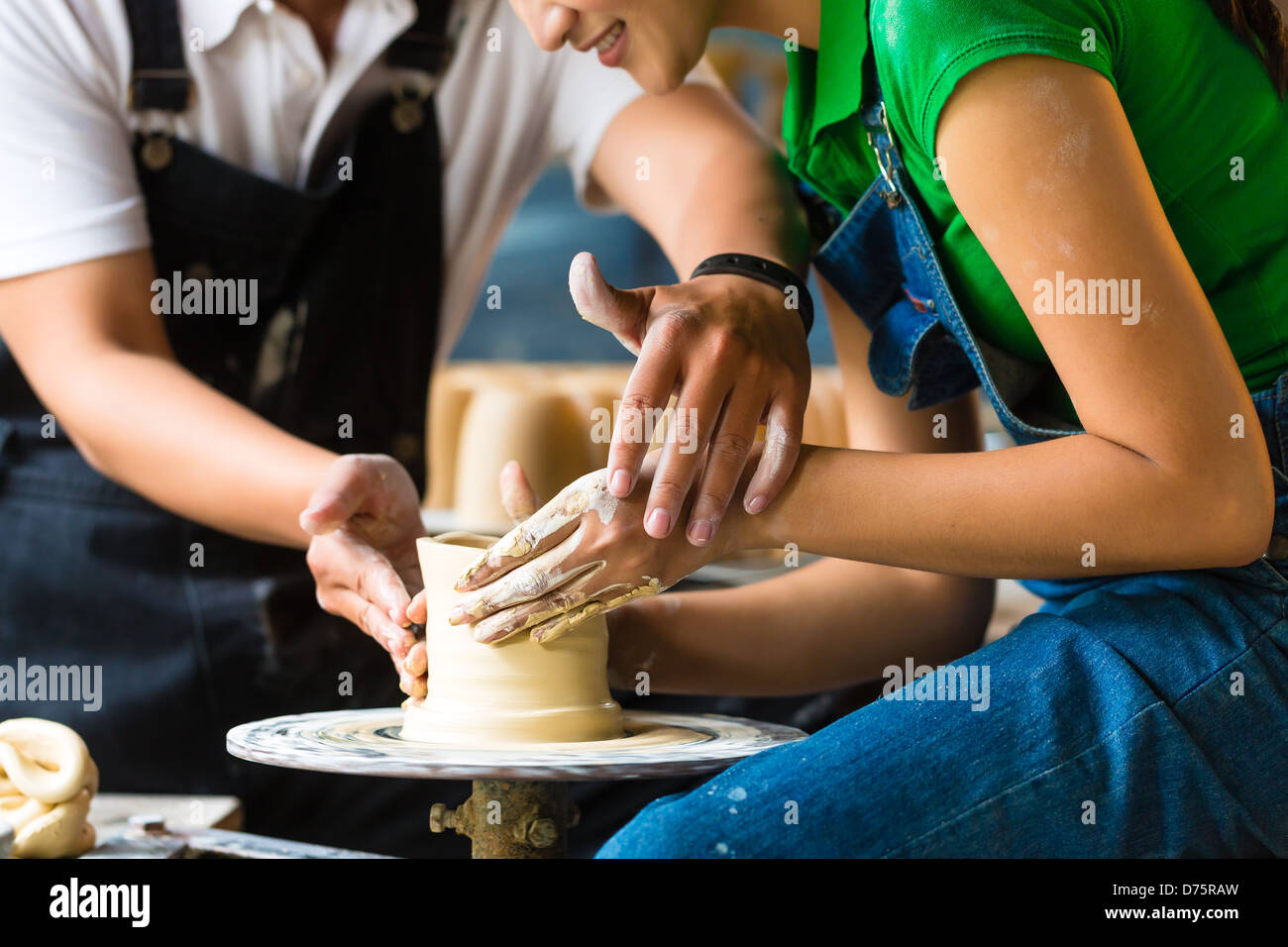 Female Potter creating a bowl on a Potters wheel, the master potter ...
