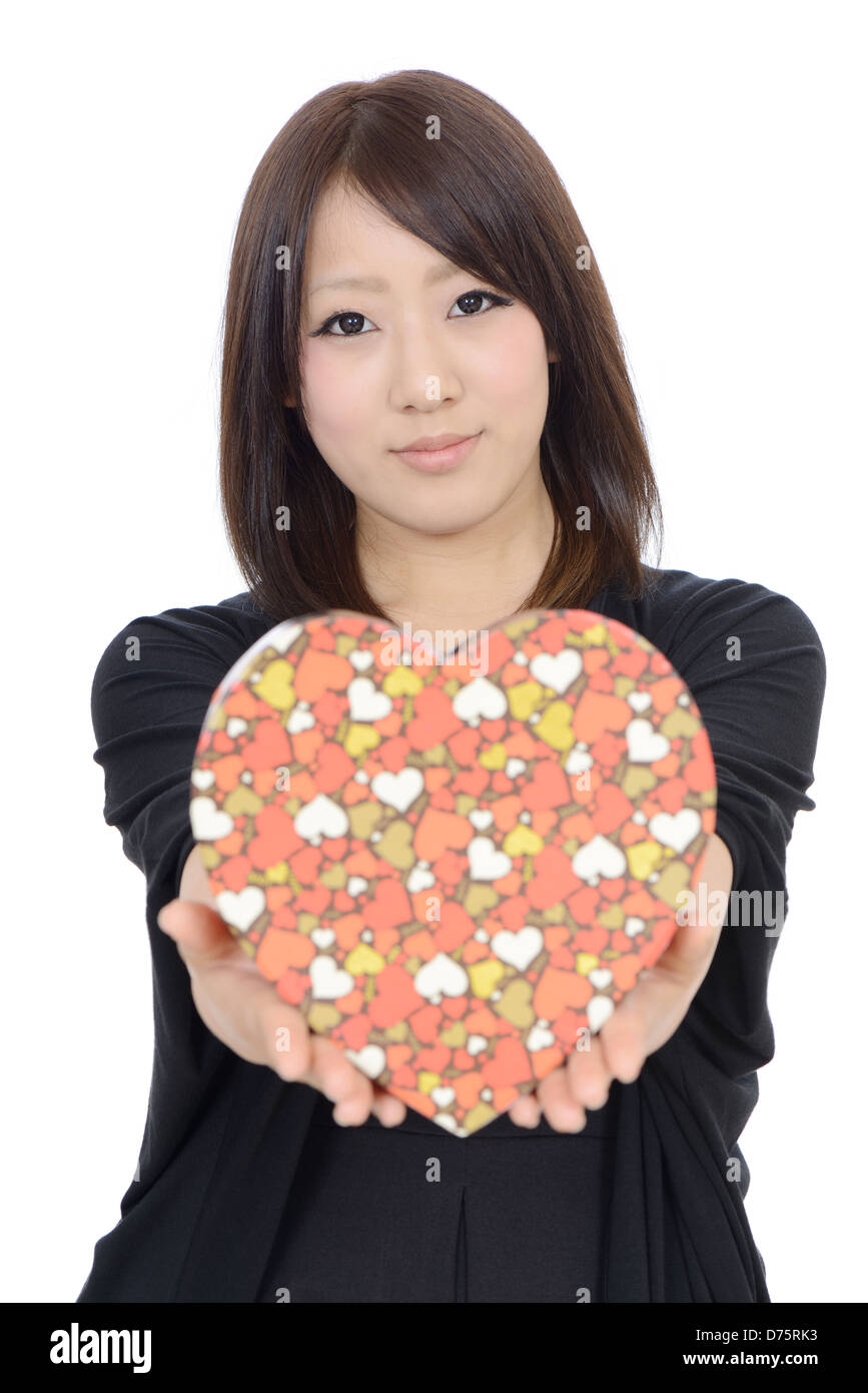 Happy young asian woman holding a gift box Stock Photo - Alamy