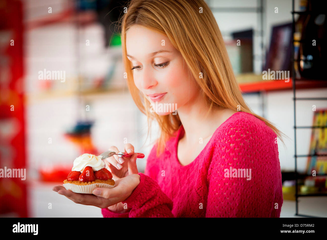 Woman eating pastry Stock Photo - Alamy