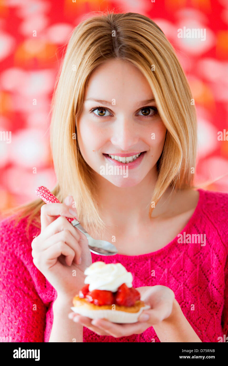 Woman eating pastry Stock Photo - Alamy