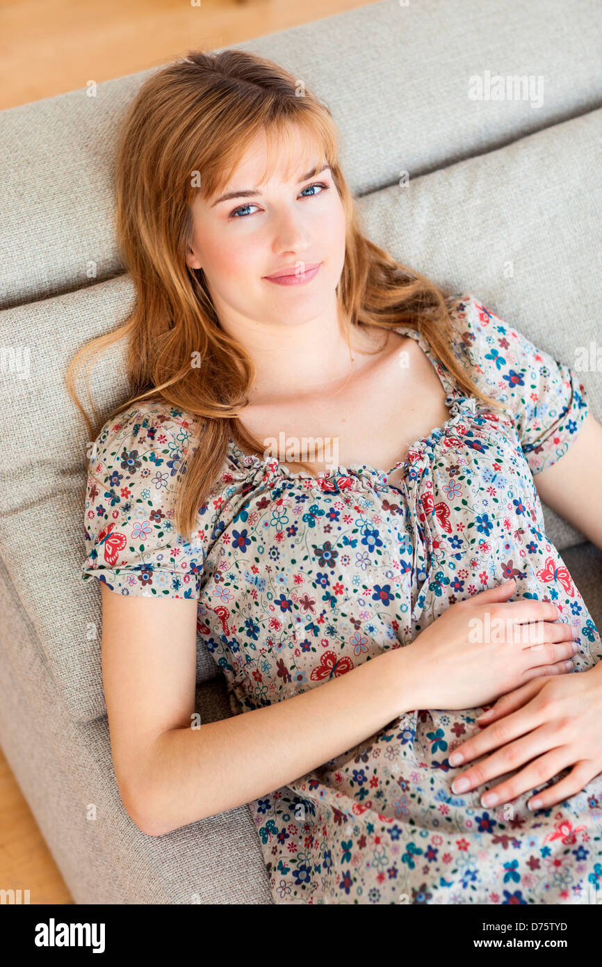 Woman relaxing on couch Stock Photo - Alamy