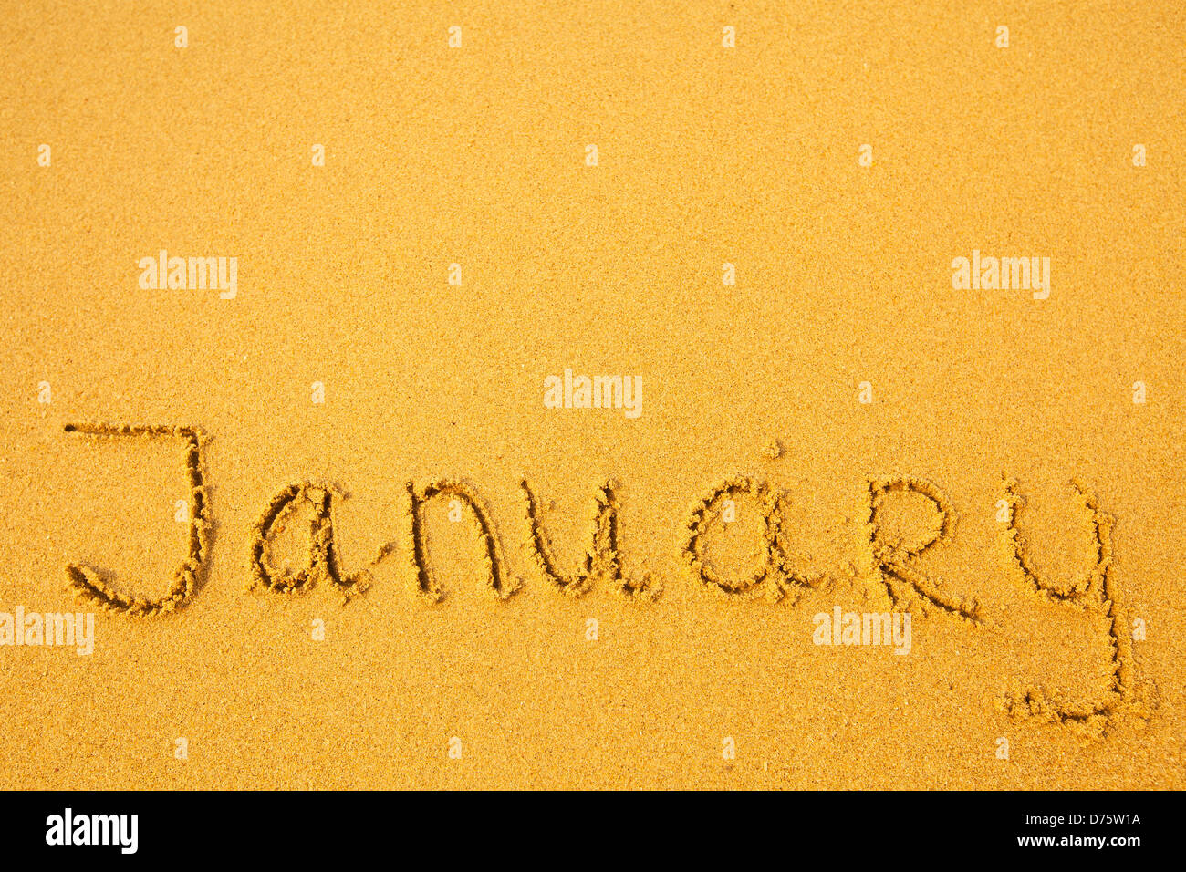 January - written in sand on beach texture (for background Stock Photo ...