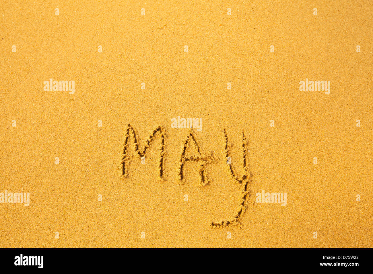 May - written in sand on beach texture (for background Stock Photo - Alamy