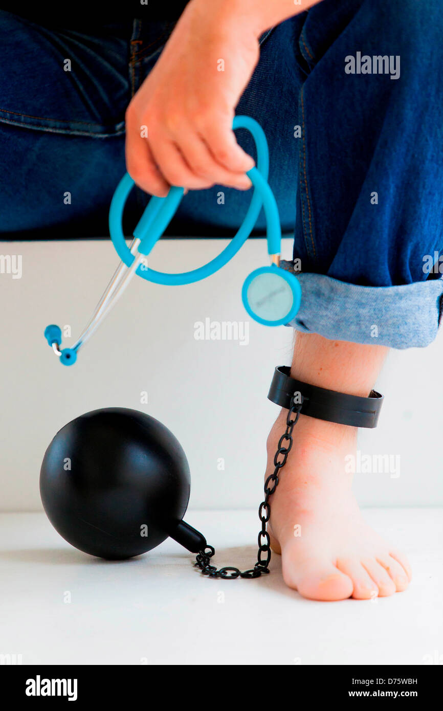 Ball and chain attached to the ankle of a general practitionner Stock ...