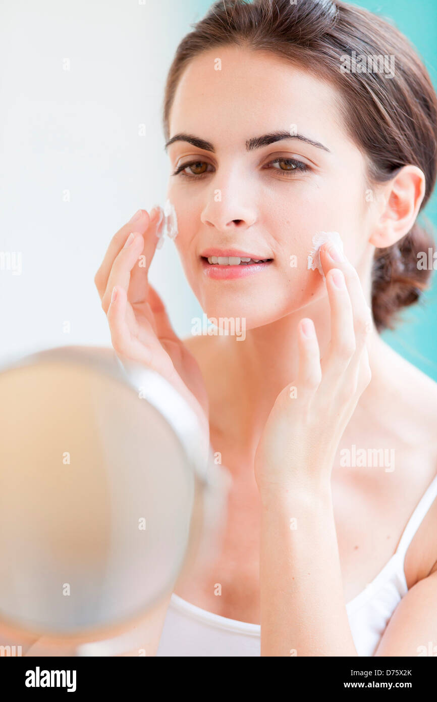 Woman 40 applying cream face bathroom hi-res stock photography and ...