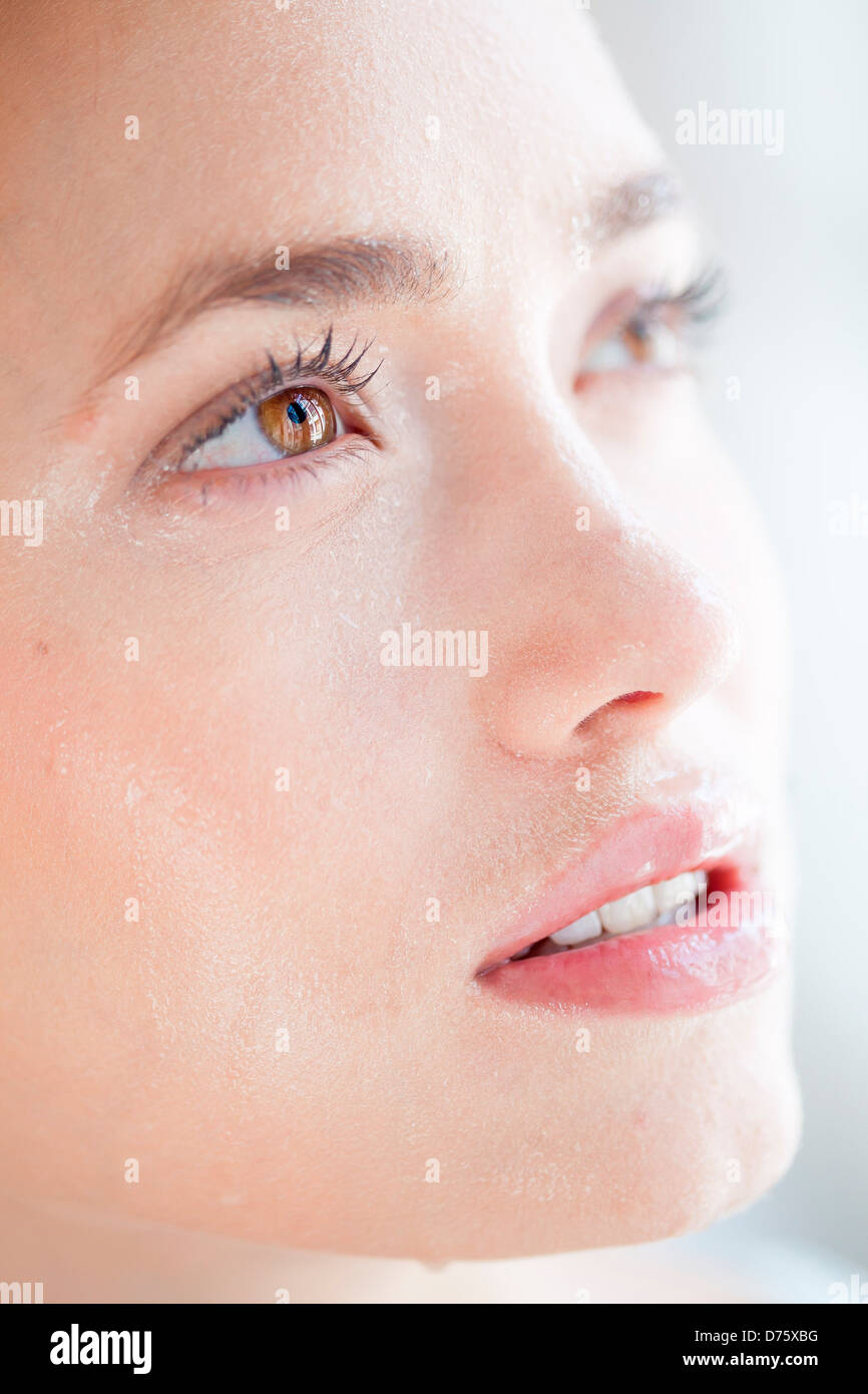 Woman spraying water on her face Stock Photo - Alamy