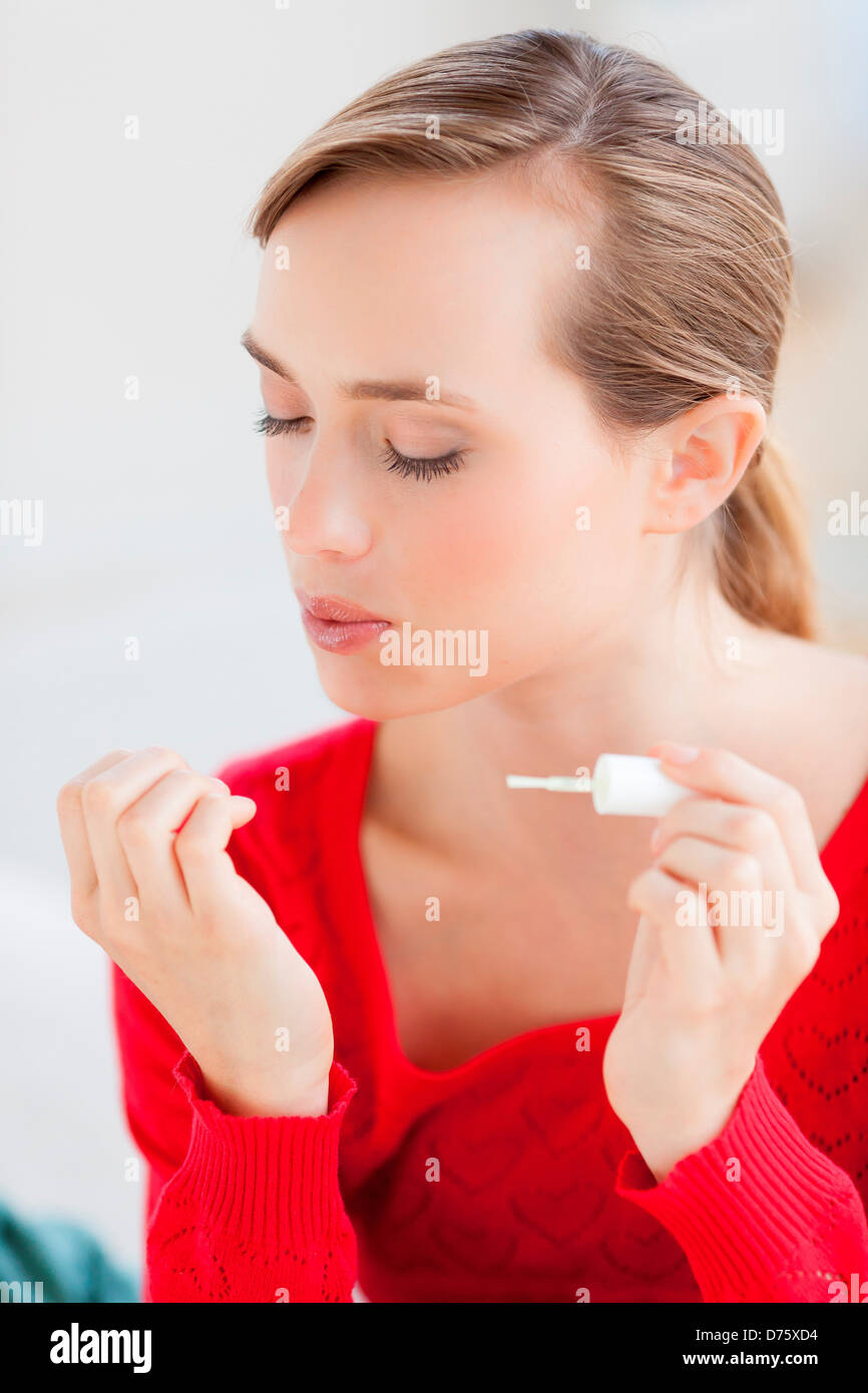 Woman applying polish on nails Stock Photo - Alamy