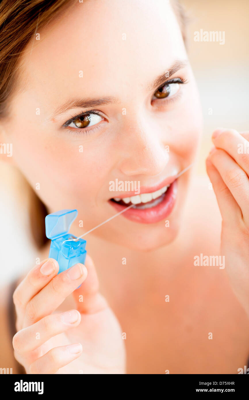 Woman using dental floss Stock Photo - Alamy