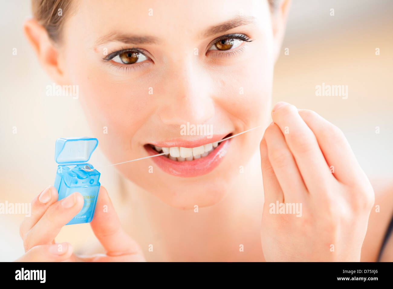 Woman using dental floss Stock Photo - Alamy