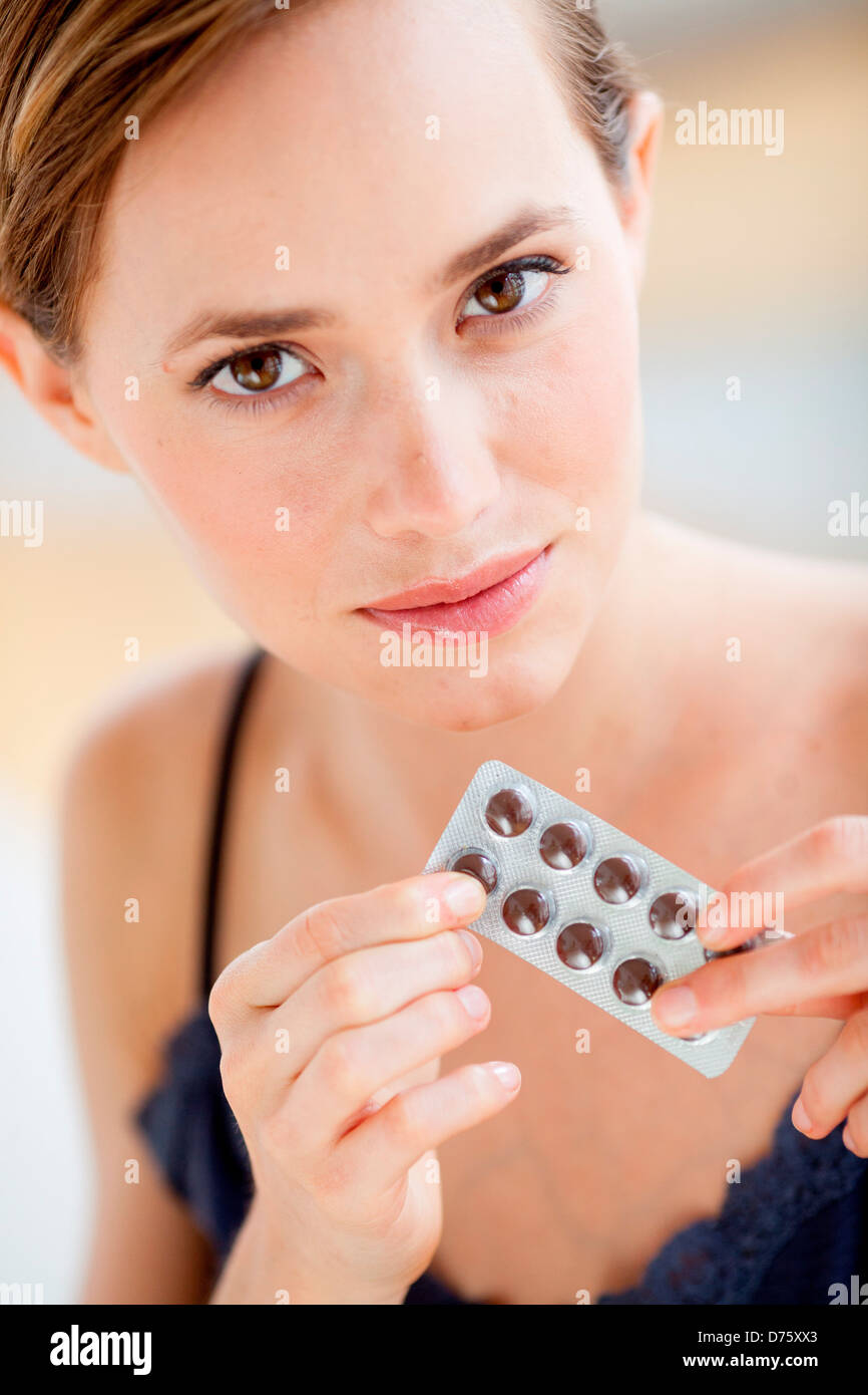 Woman taking medicine Stock Photo - Alamy