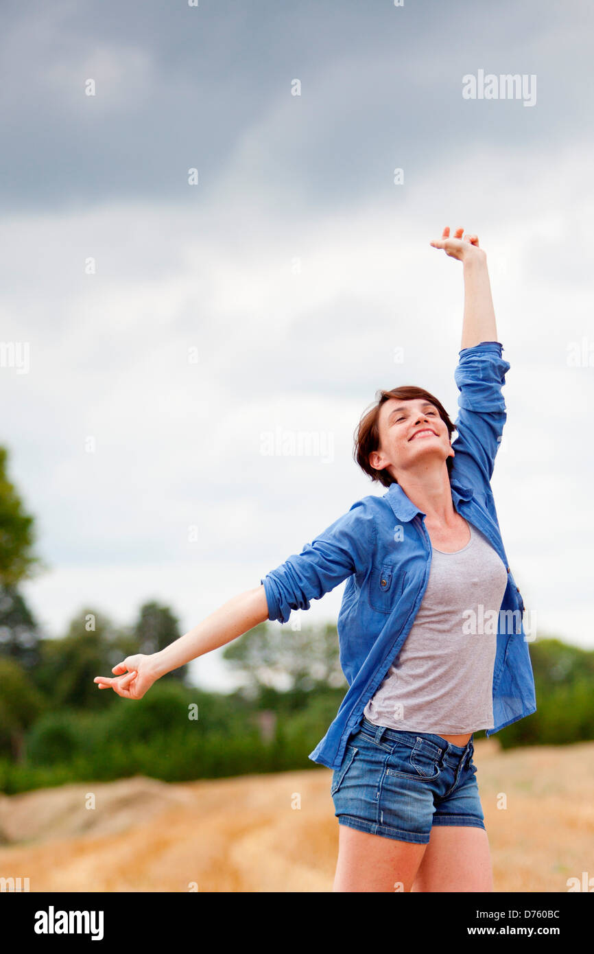 Woman stretching in a field Stock Photo - Alamy