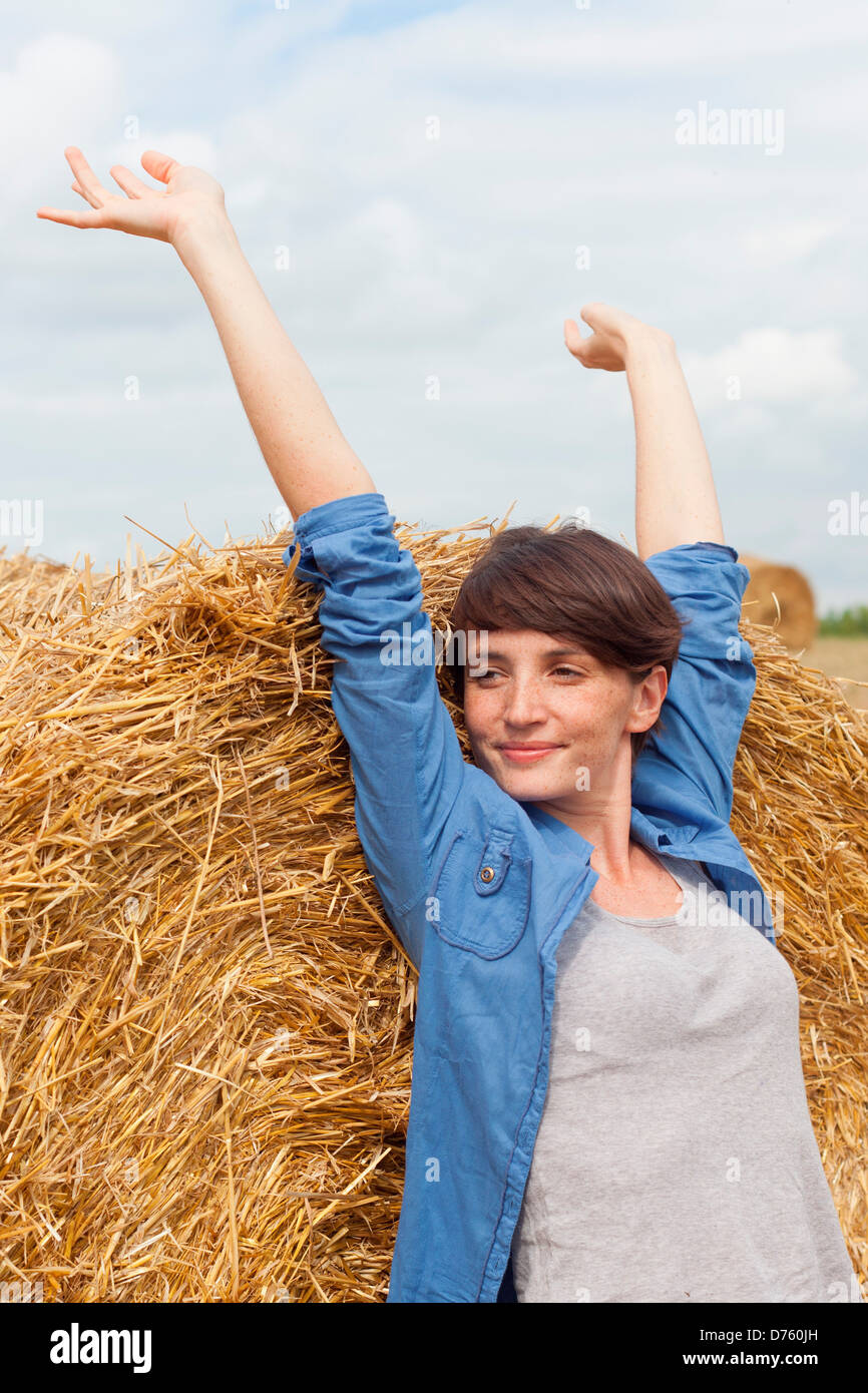 Woman stretching in a field Stock Photo - Alamy