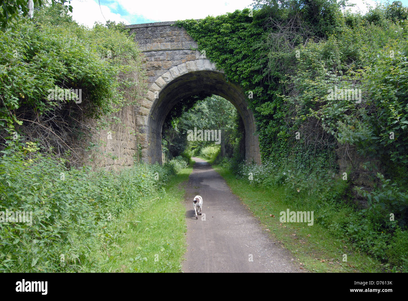 A stone bridge over the cycle path along the disused railway line ...