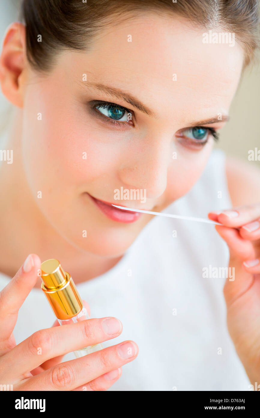 Woman smelling a perfume Stock Photo - Alamy