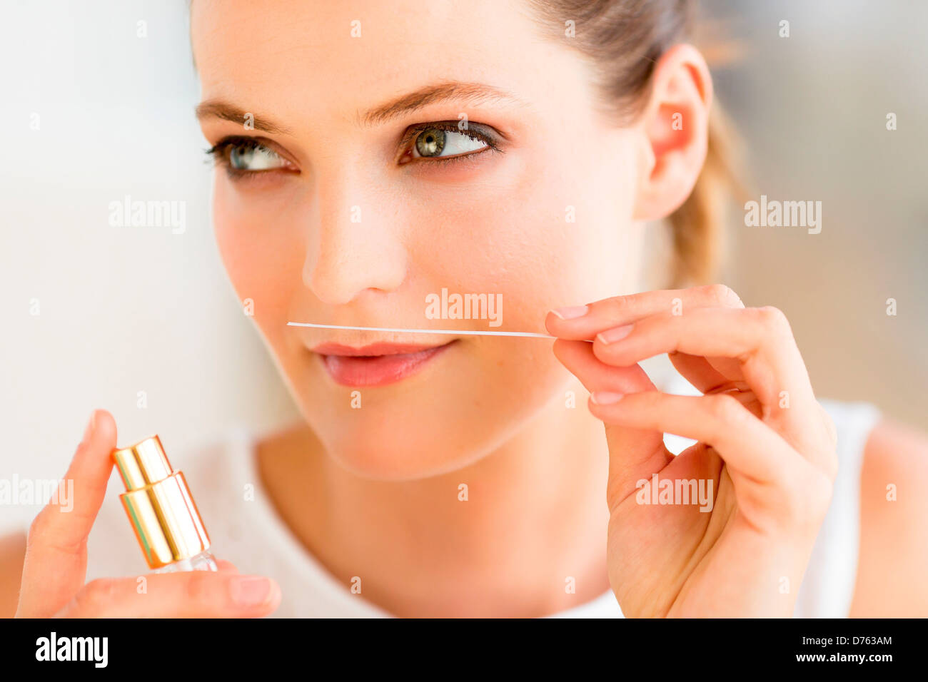 Woman smelling a perfume Stock Photo - Alamy