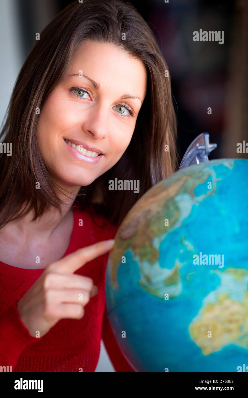 Woman looking at a map of the world Stock Photo - Alamy