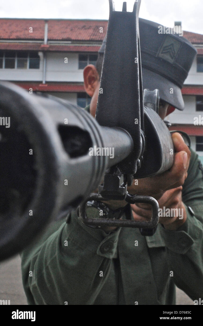 Uniformed police officer aiming an assault rifle tactical firearms ...