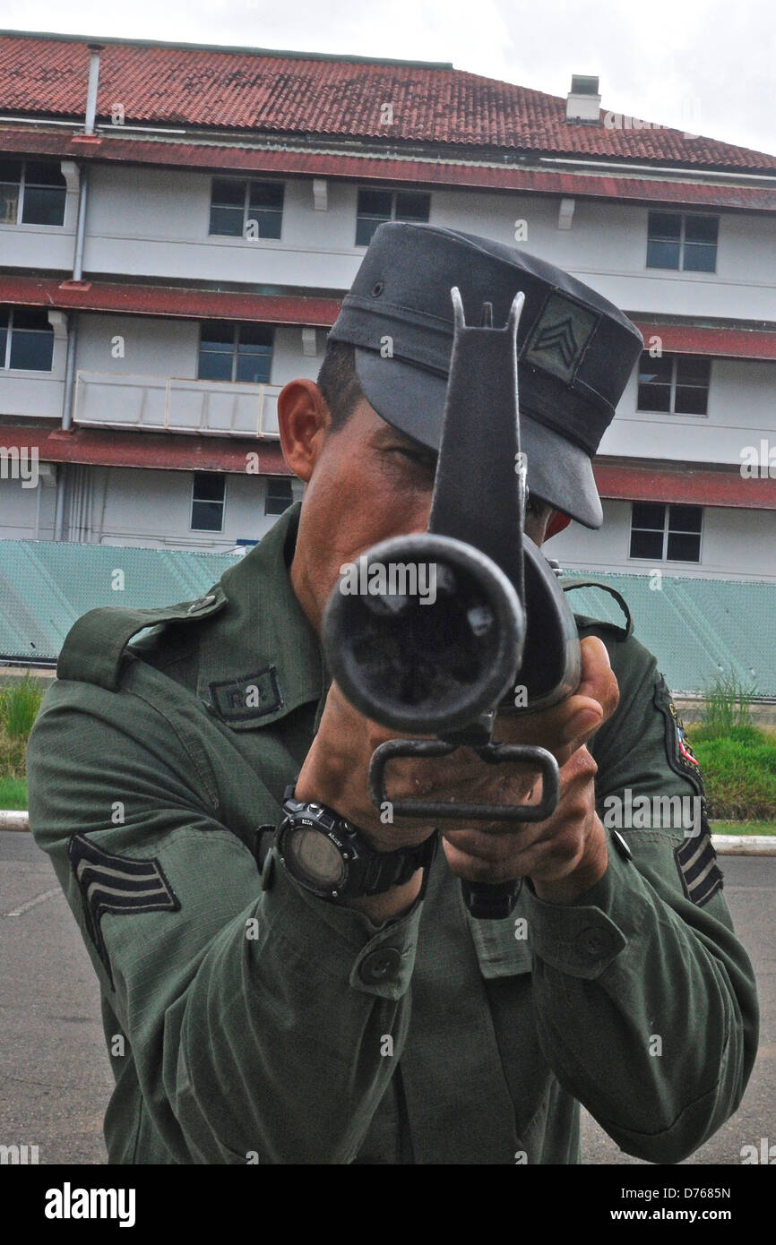 Uniformed police officer aiming an assault rifle tactical firearms ...