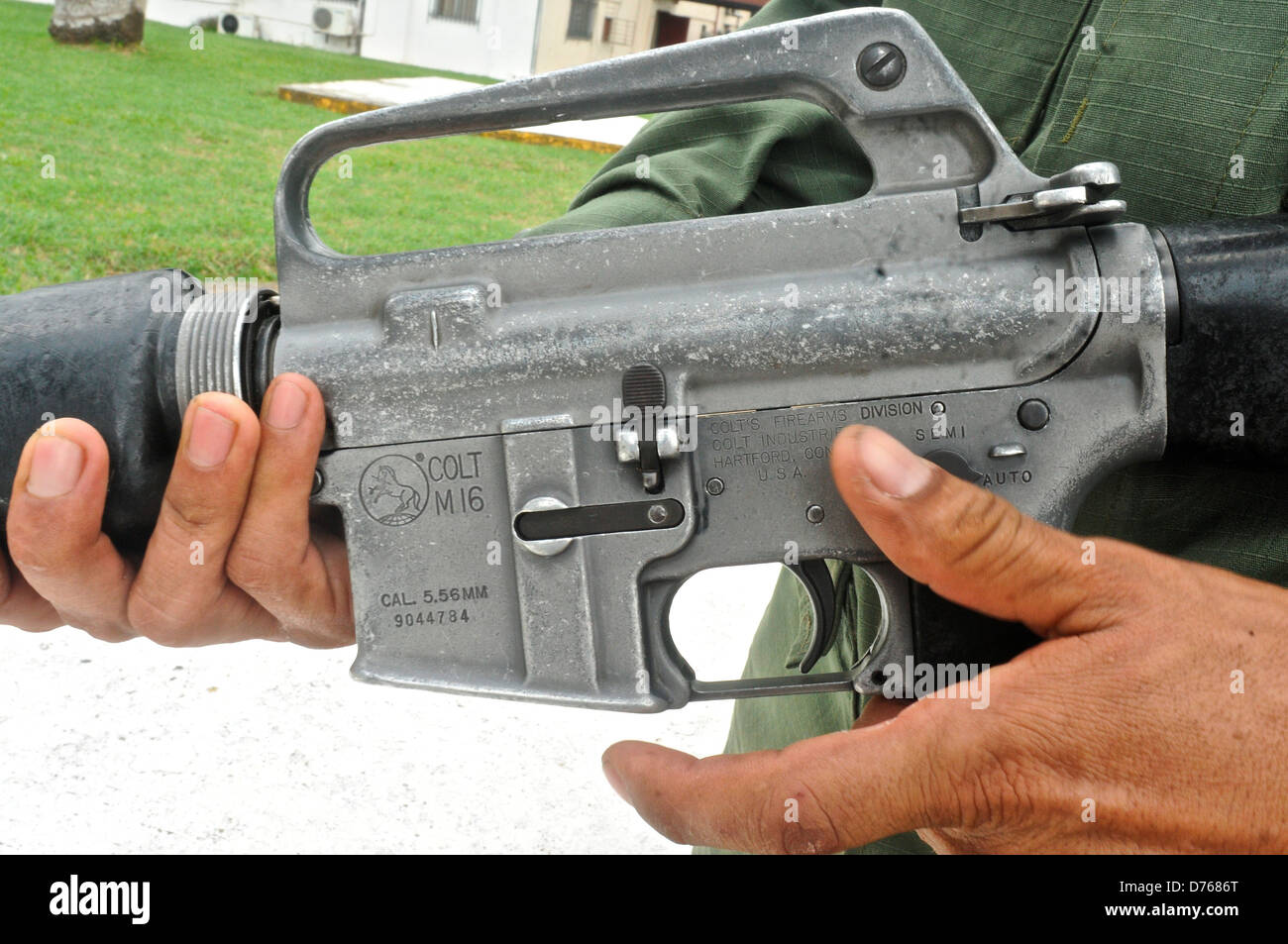 Uniformed police officer aiming an assault rifle tactical firearms ...