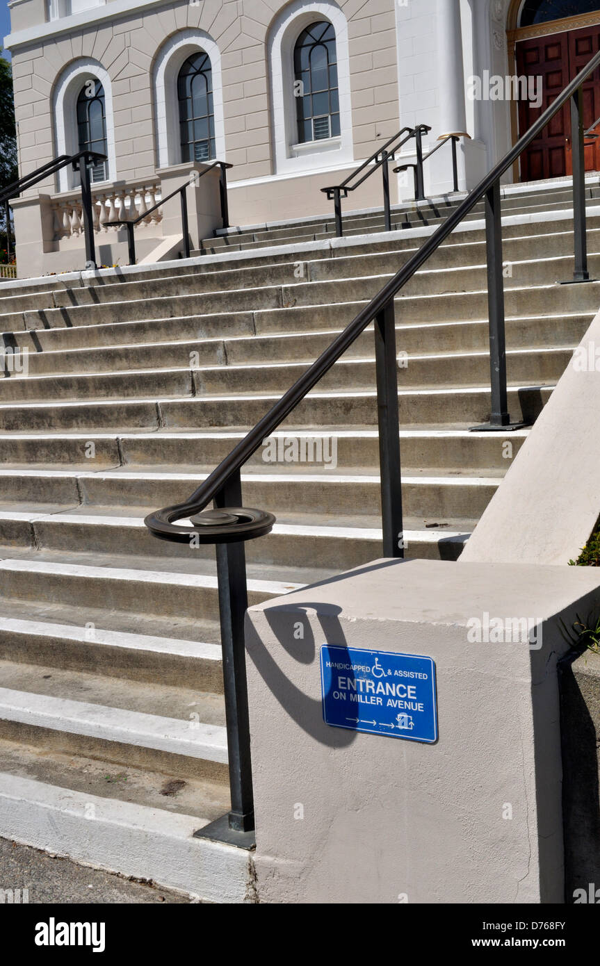 handicapped assisted entrance direction sign Stock Photo - Alamy