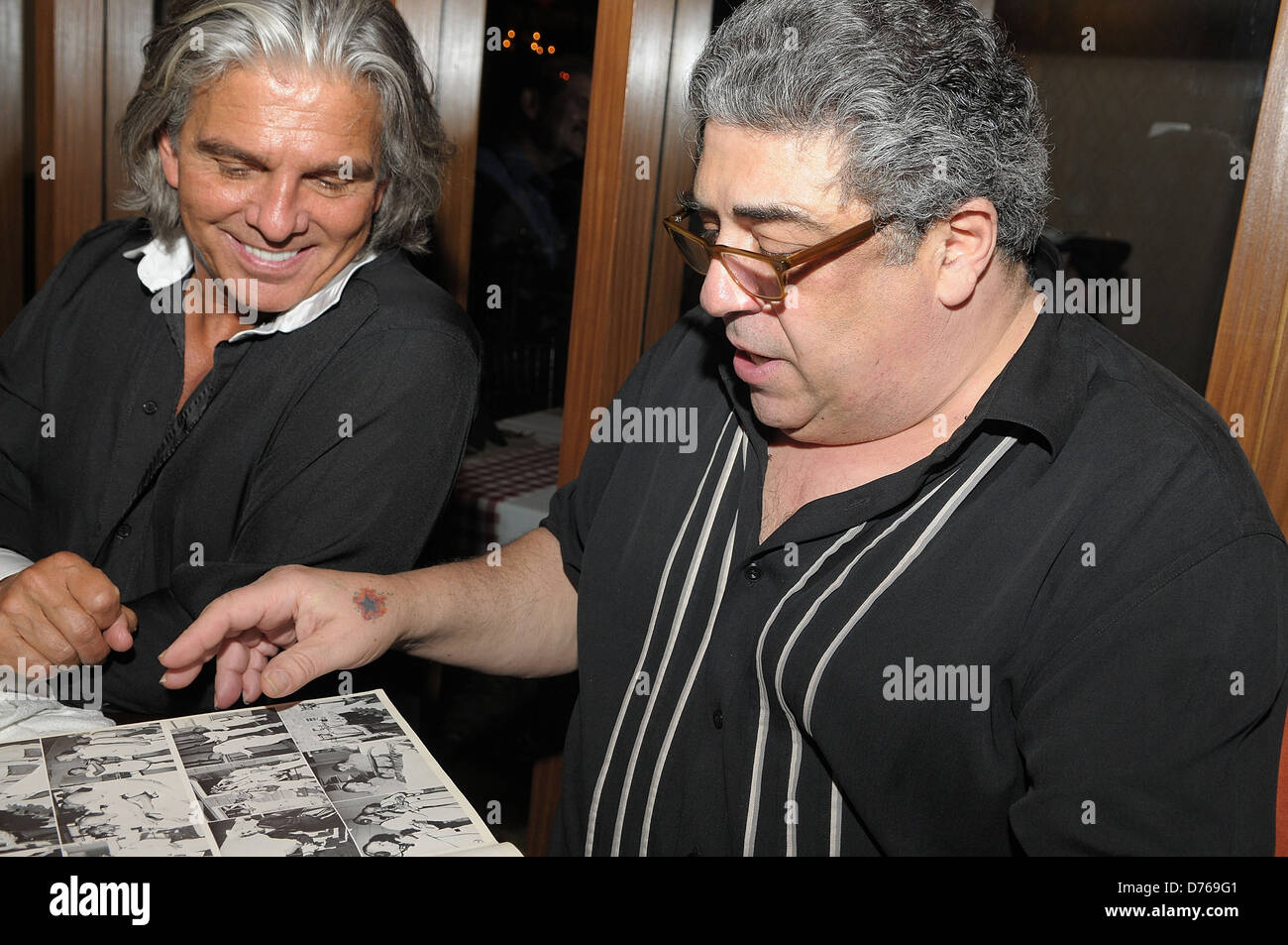 John Gennaro with Vincent Pastore looking at photo albums which ...