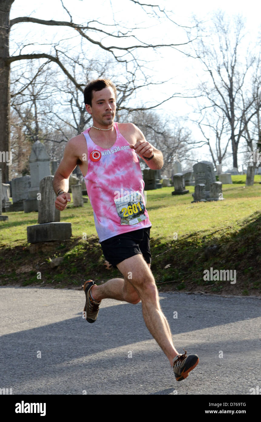 Runner races down incline competing in Half Marathon Stock Photo - Alamy